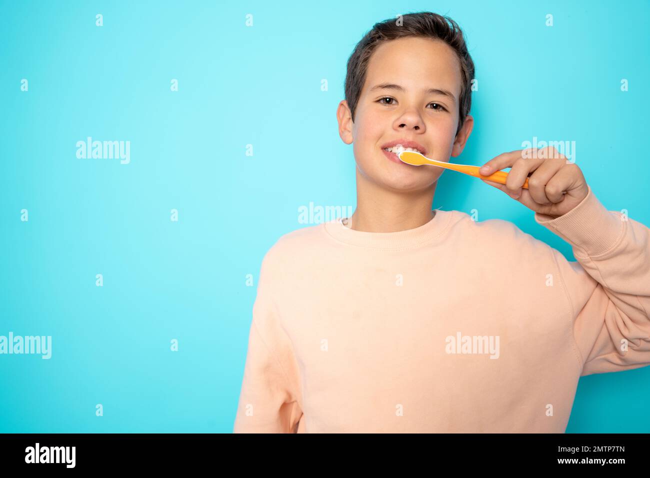 Young Boy brushing teeth, isolated on green background Stock Photo - Alamy