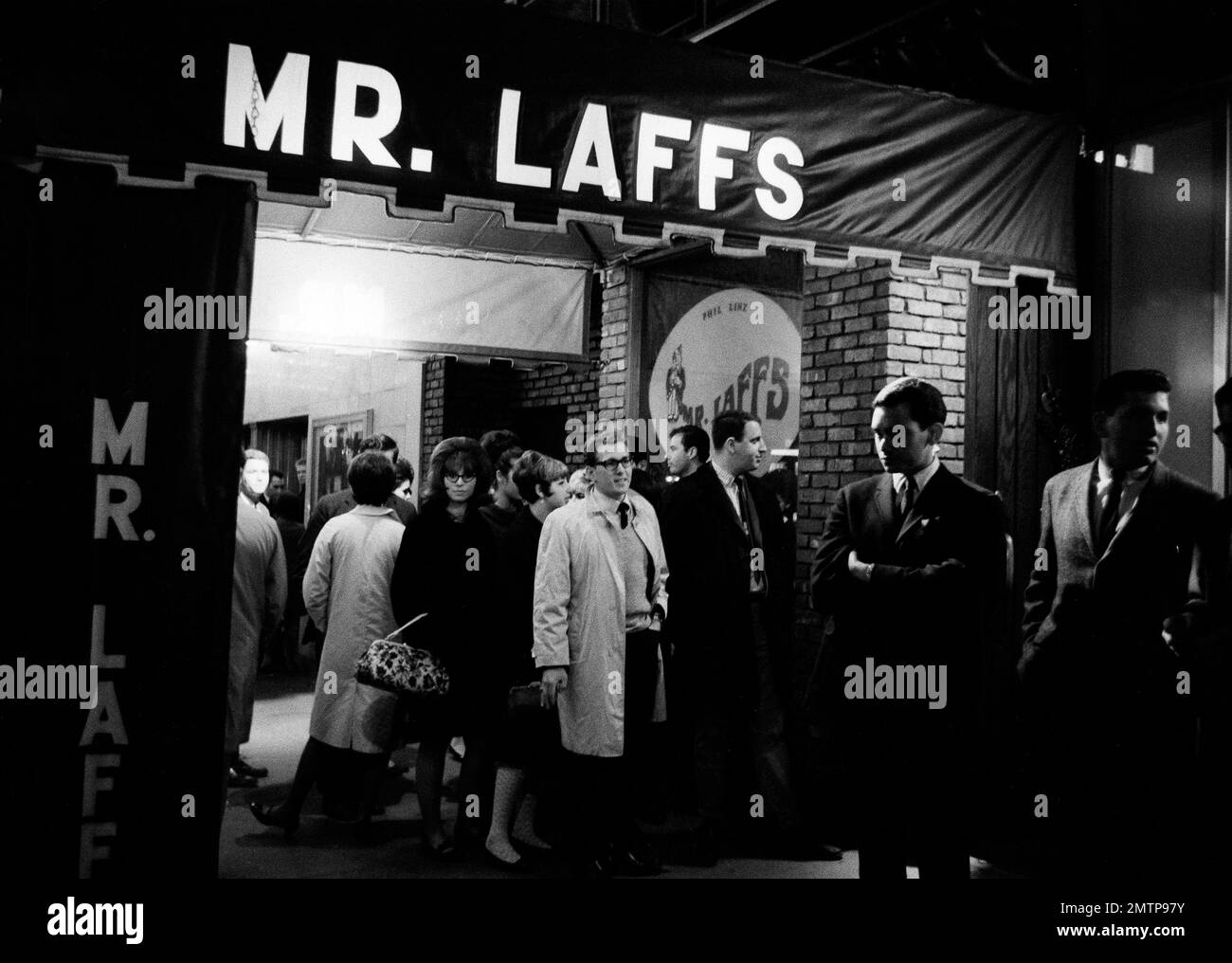Members of today's "smart-set" mill about in front of the fashionable ...