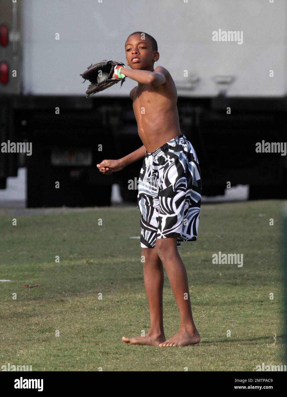 Spike Lee and his son Jackson play a game of catch by the pool of their ...