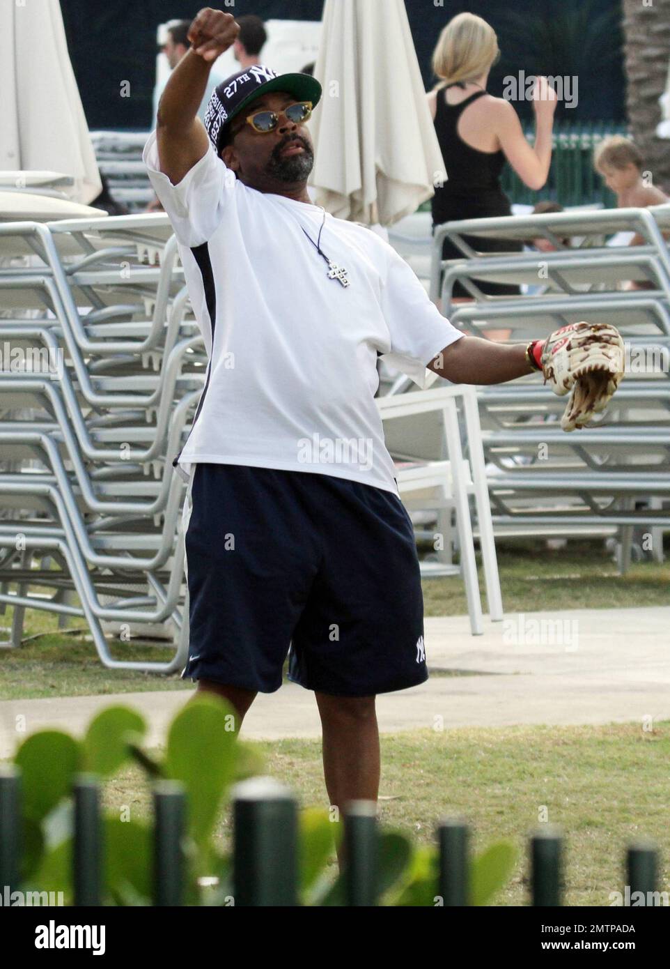 Spike Lee and his son Jackson play a game of catch by the pool of their ...