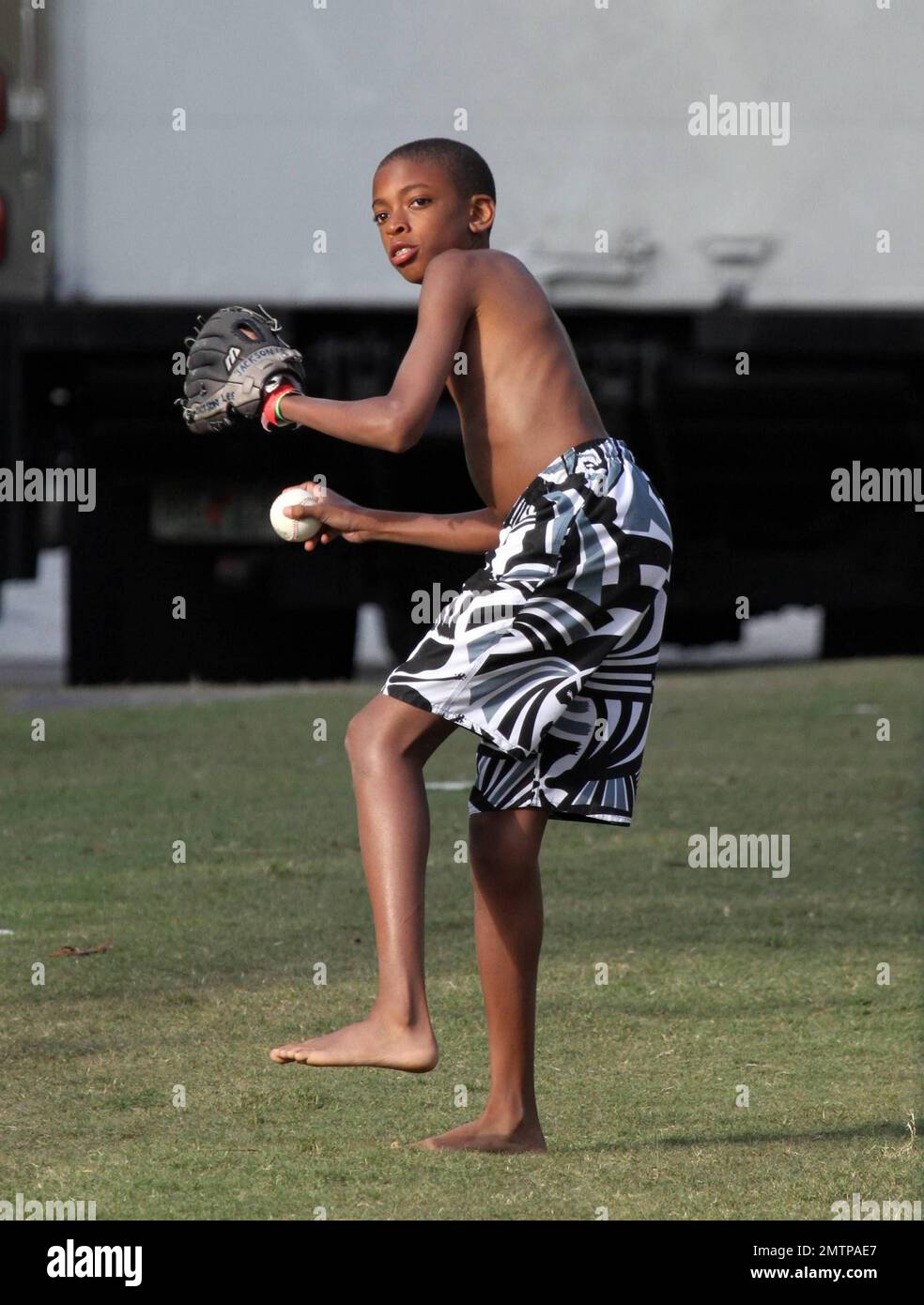 Spike Lee and his son Jackson play a game of catch by the pool of their ...