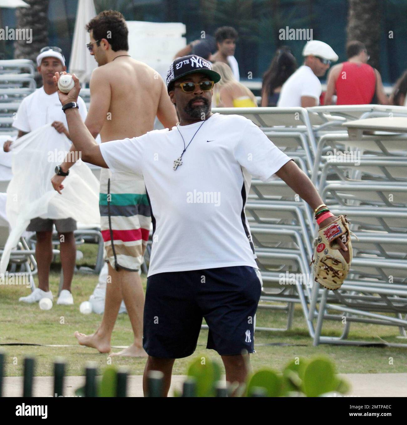 Spike Lee and his son Jackson play a game of catch by the pool of their ...