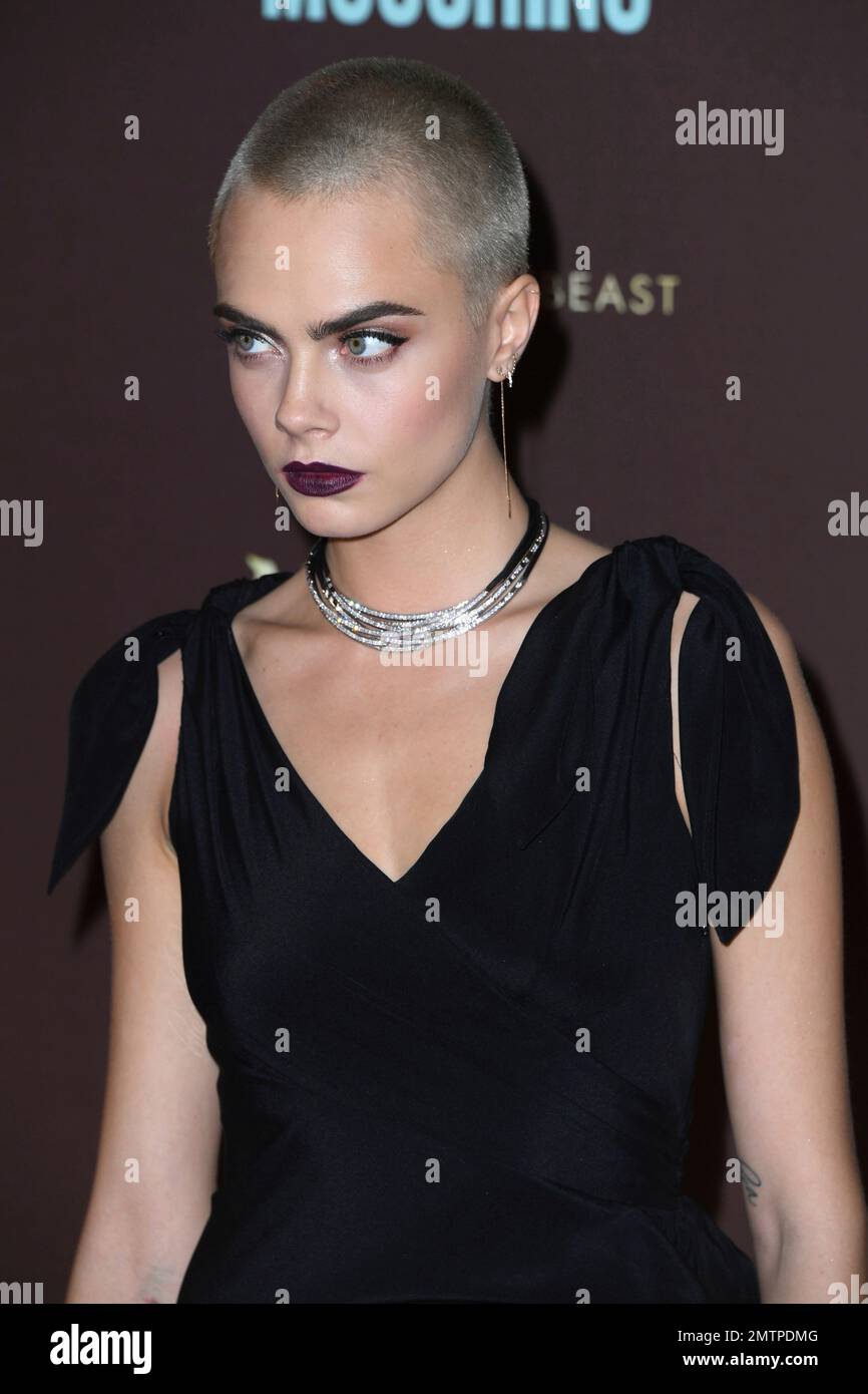 Model Cara Delevingne Poses For Photographers Upon Arrival At The