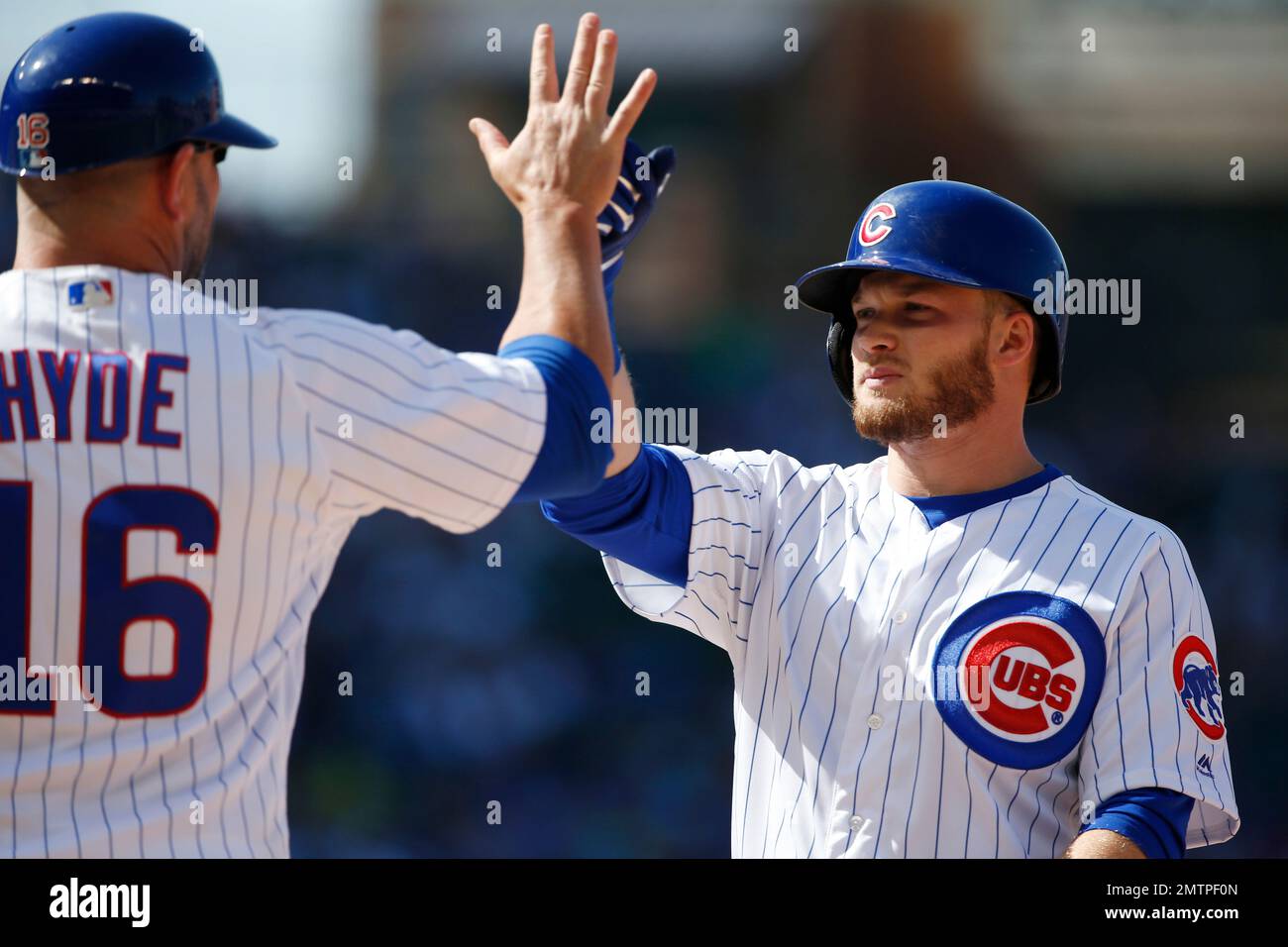 Chicago Cubs' Ian Happ, right, celebrates with first base coach Brandon ...