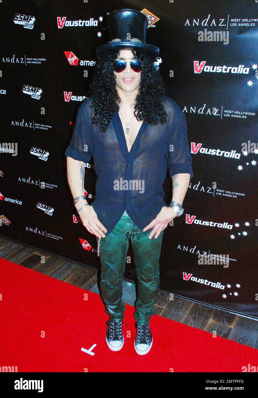 Slash poses on the red carpet at the Get Stripped: Virgin America ...