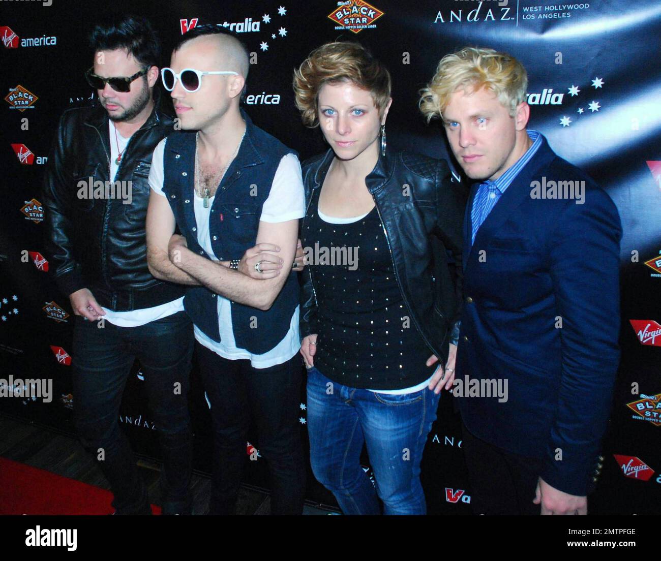 Guests pose on the red carpet at the Get Stripped: Virgin America ...