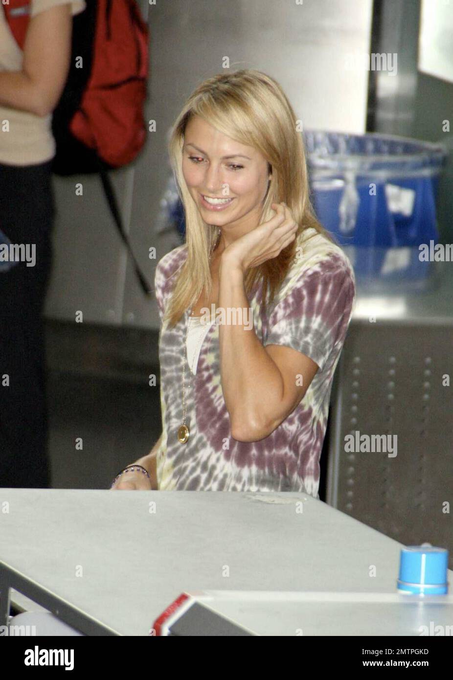 Stacy Keibler and boyfriend Geoff Stults head through an LAX security ...
