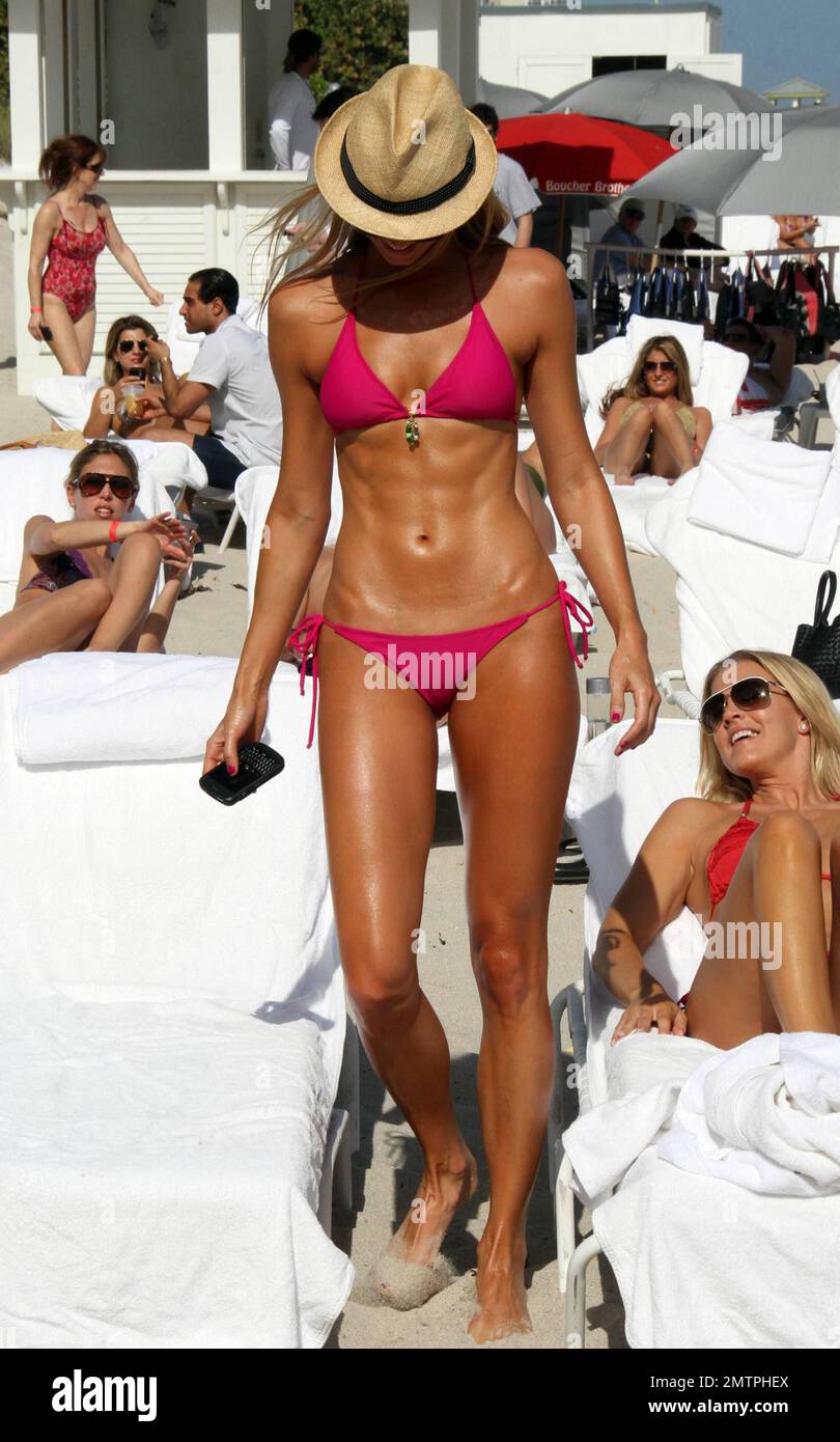 Stacy Keibler flaunts her perfect figure in a tiny hot pink bikini beachside at her luxury hotel ...
