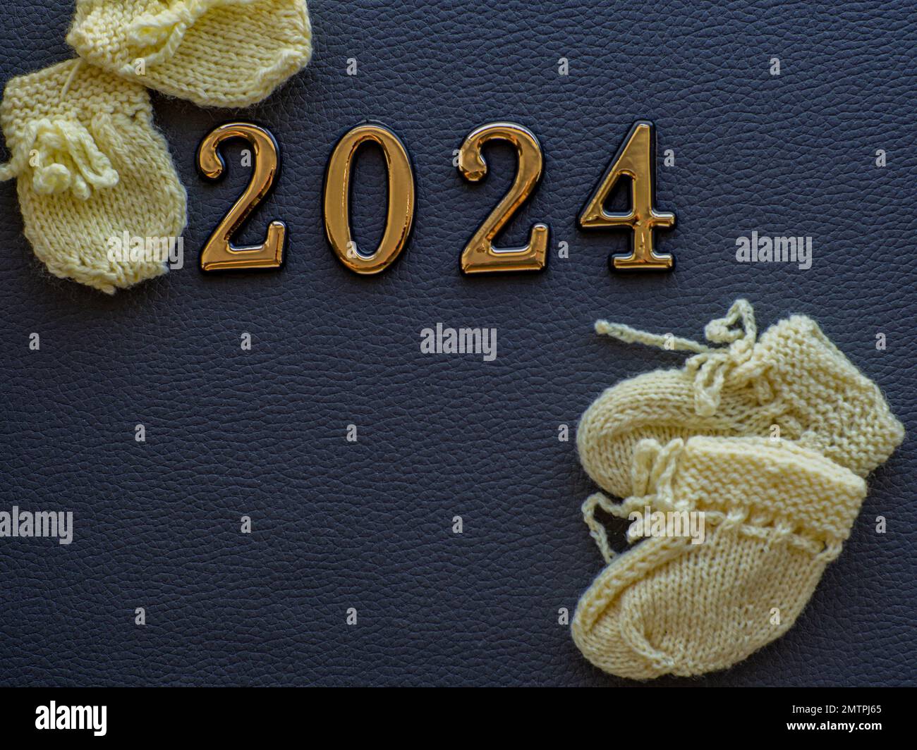 Small baby shoes with 2024 typography Stock Photo - Alamy