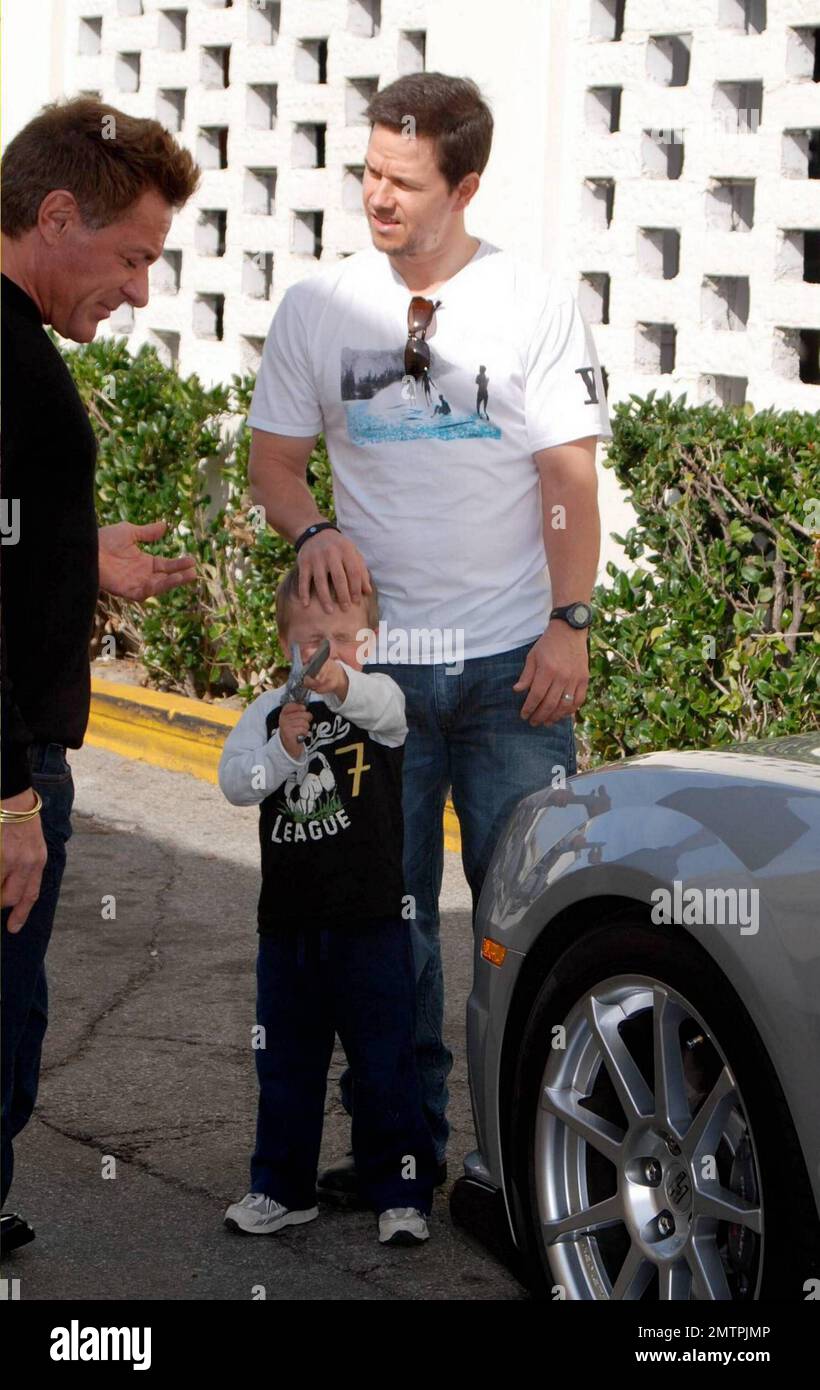 Sylvester Stallone shows off his new Chevy Camaro to Mark Wahlberg and his son after a business ...