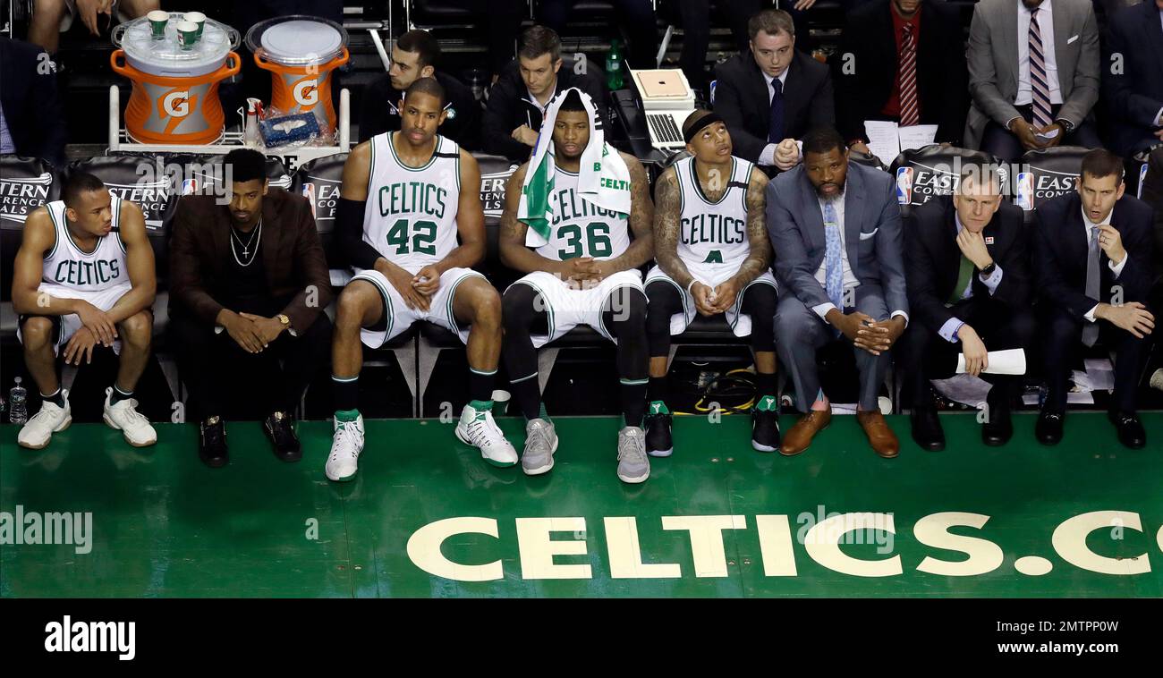 Boston Celtics players and coaches watch from the bench during the ...