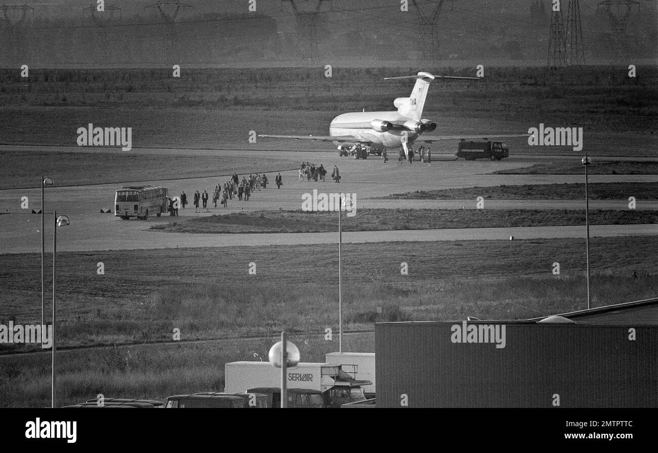 Passengers of the hijacked TWA Flight 355 leave the plane at Charles de ...