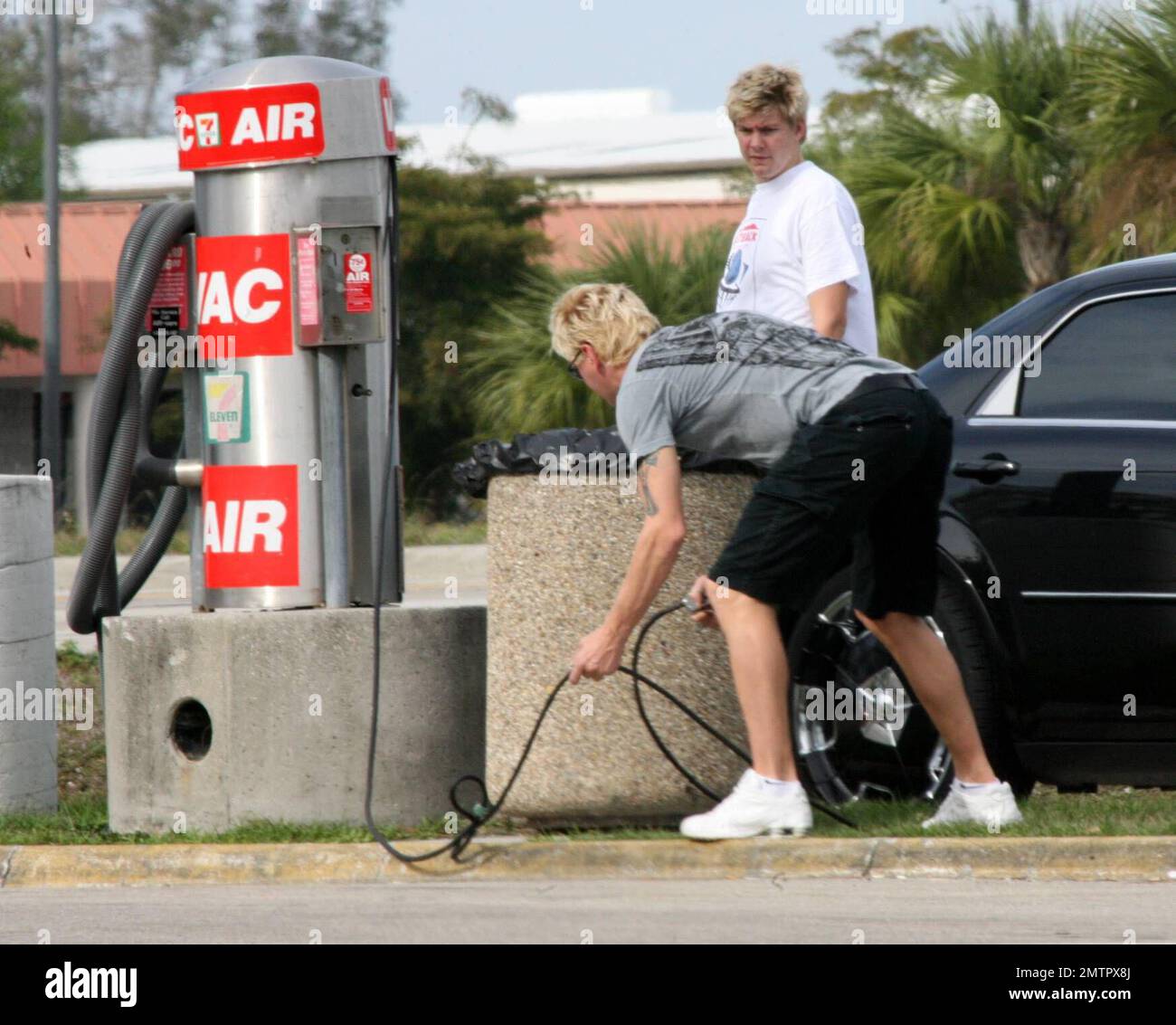 Exclusive!! German soccer ace Stefan Effenberg helps his son put air in ...