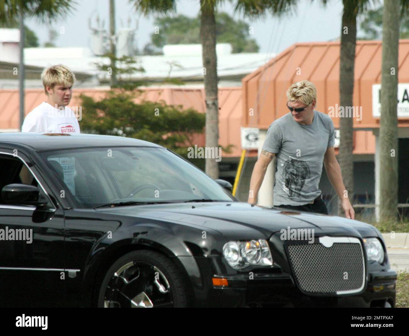 Exclusive!! German soccer ace Stefan Effenberg helps his son put air in ...