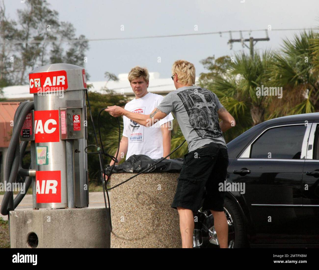 Exclusive!! German soccer ace Stefan Effenberg helps his son put air in ...