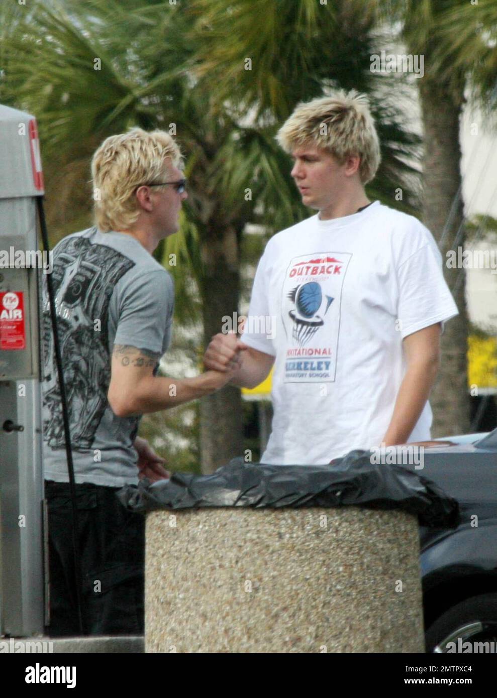 Exclusive!! German soccer ace Stefan Effenberg helps his son put air in ...