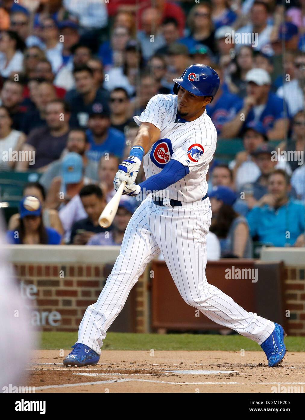 Chicago Cubs' Jeimer Candelario hits an RBI single off Cincinnati Reds ...