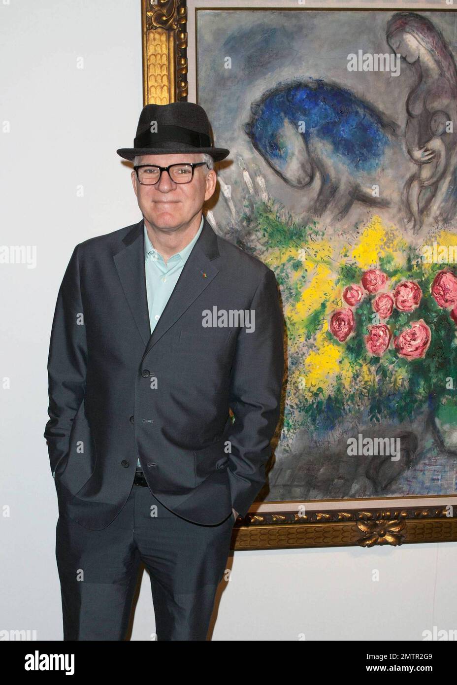 Actor, comedian and musician Steve Martin poses for photos while ...
