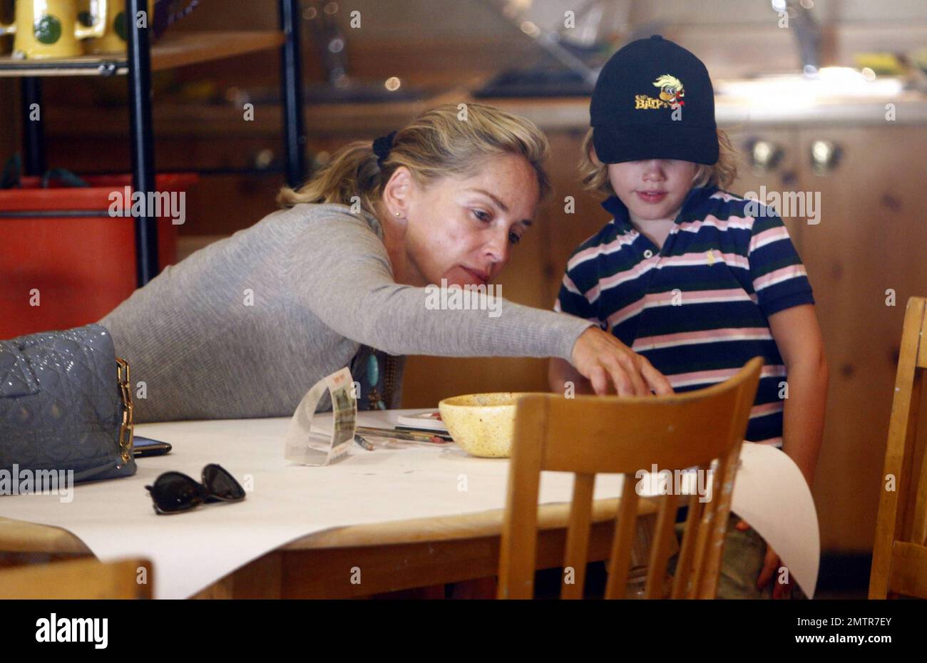 Wearing a simple blue dress and sandals, Sharon Stone takes son Laird ...