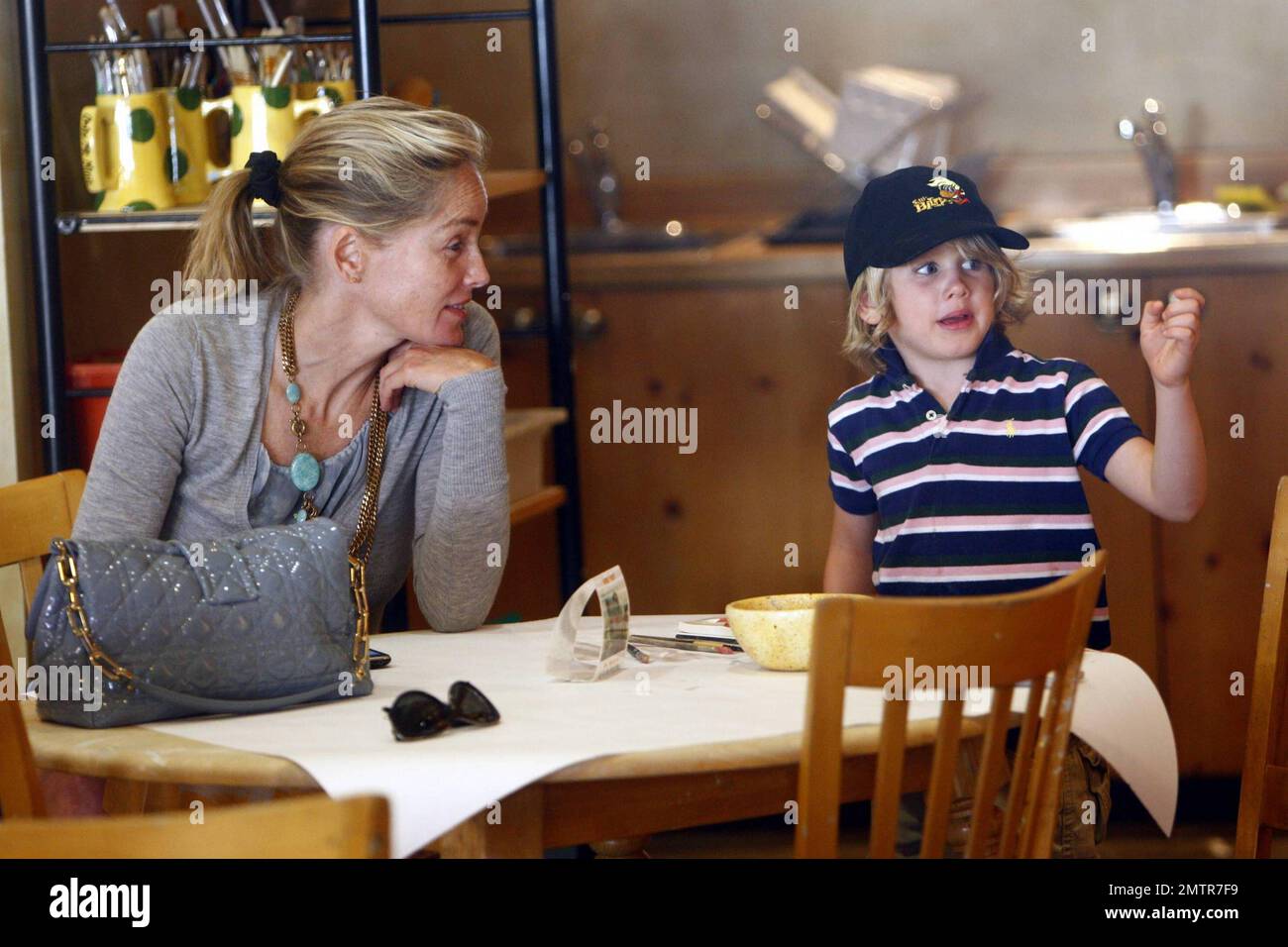 Wearing a simple blue dress and sandals, Sharon Stone takes son Laird ...