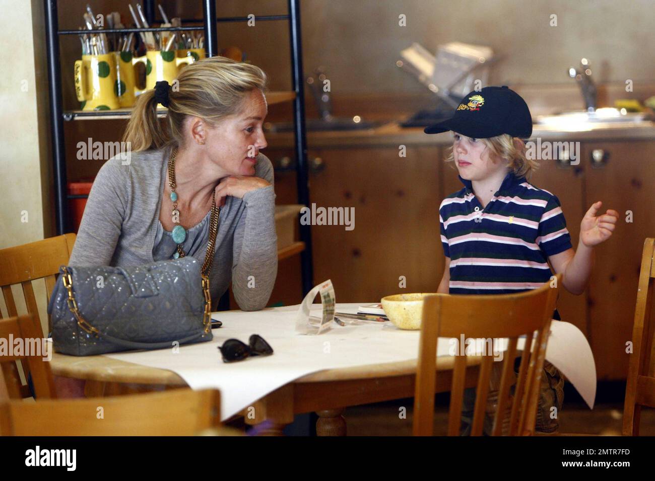 Wearing a simple blue dress and sandals, Sharon Stone takes son Laird ...