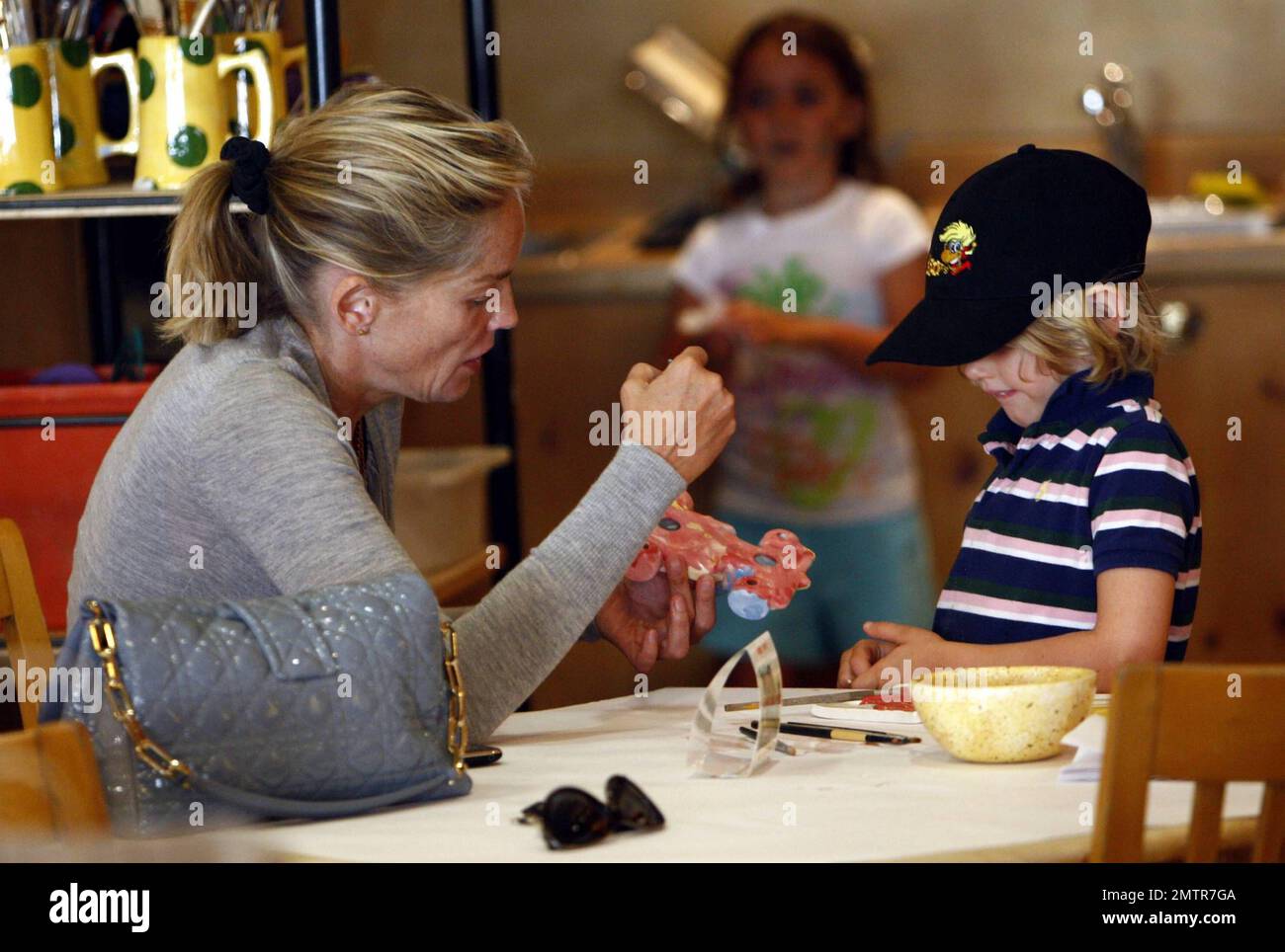 Wearing a simple blue dress and sandals, Sharon Stone takes son Laird ...