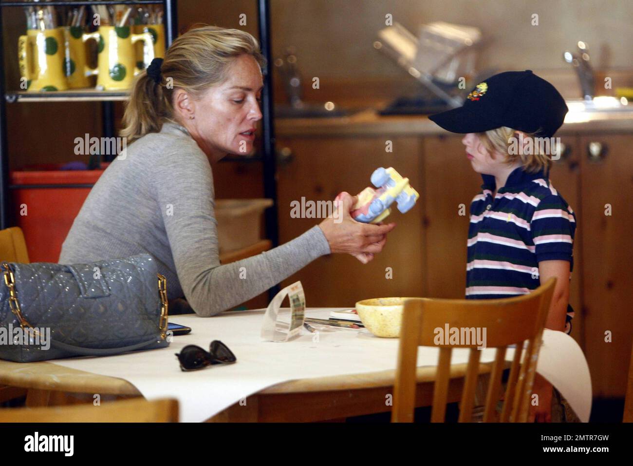 Wearing a simple blue dress and sandals, Sharon Stone takes son Laird ...