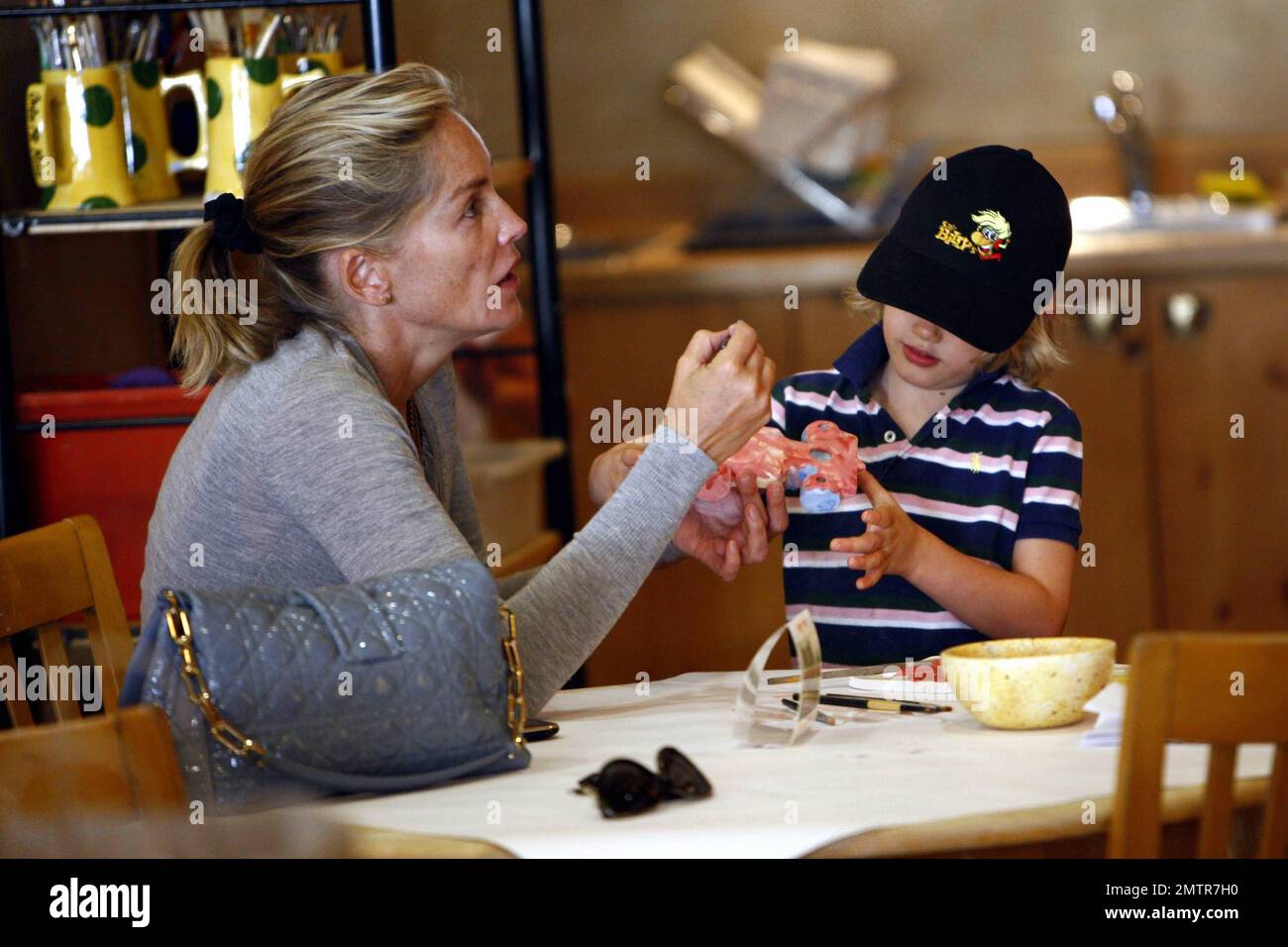 Wearing a simple blue dress and sandals, Sharon Stone takes son Laird ...