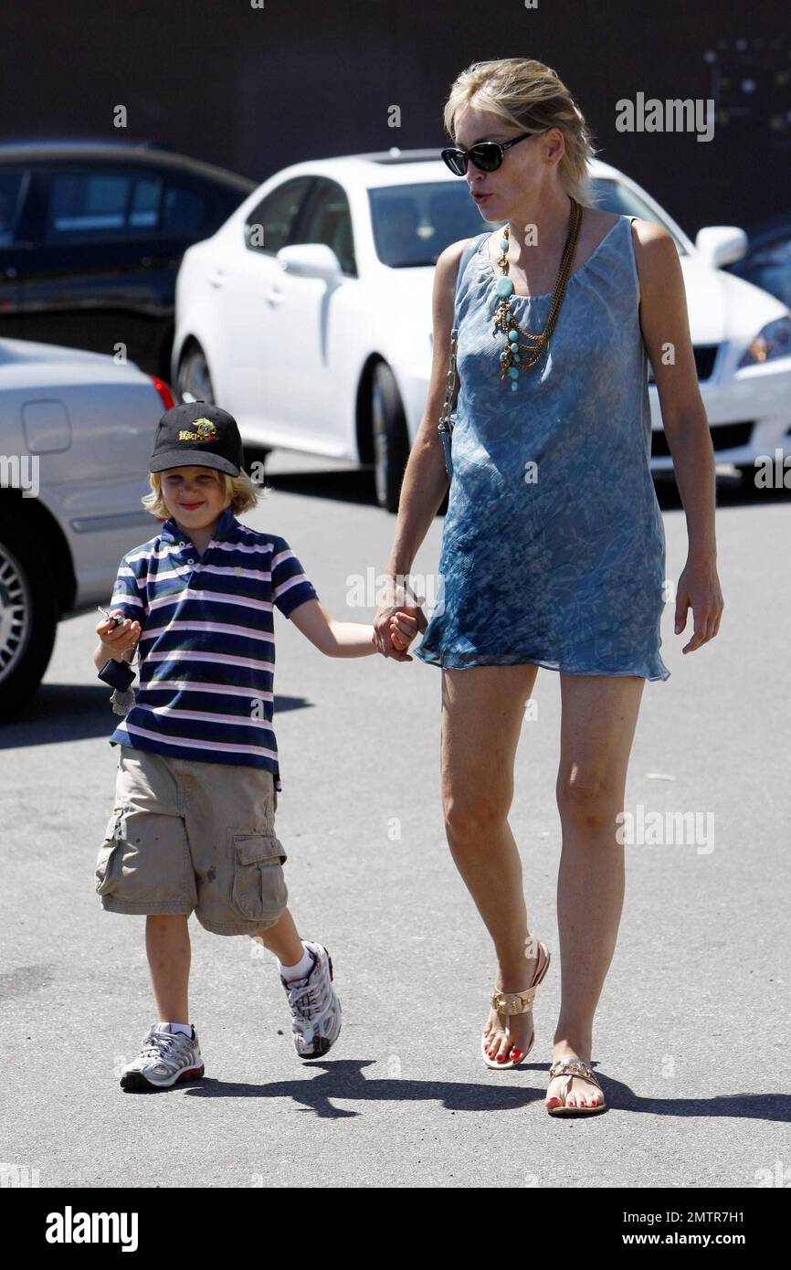 Wearing a simple blue dress and sandals, Sharon Stone takes son Laird ...