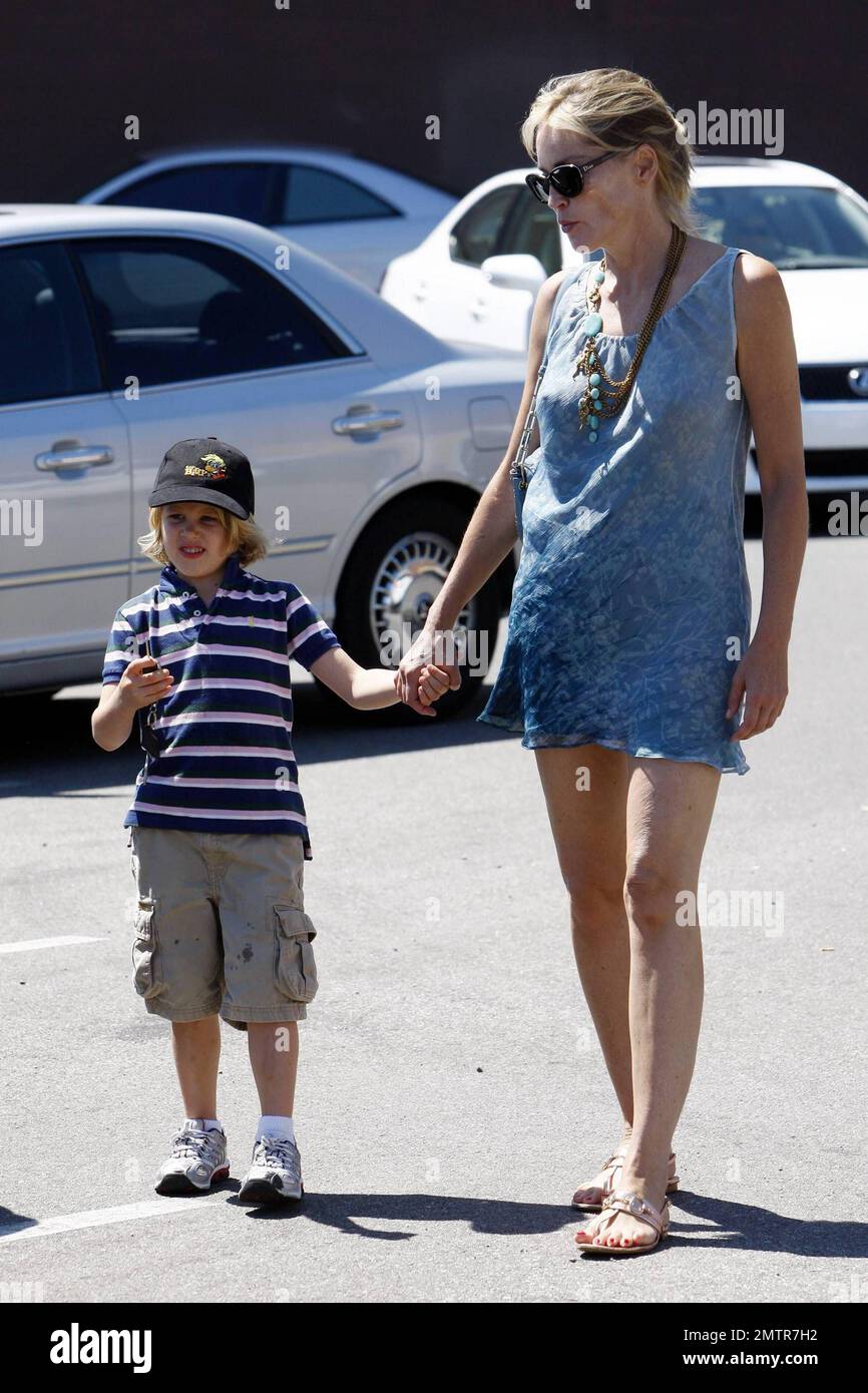 Wearing a simple blue dress and sandals, Sharon Stone takes son Laird ...
