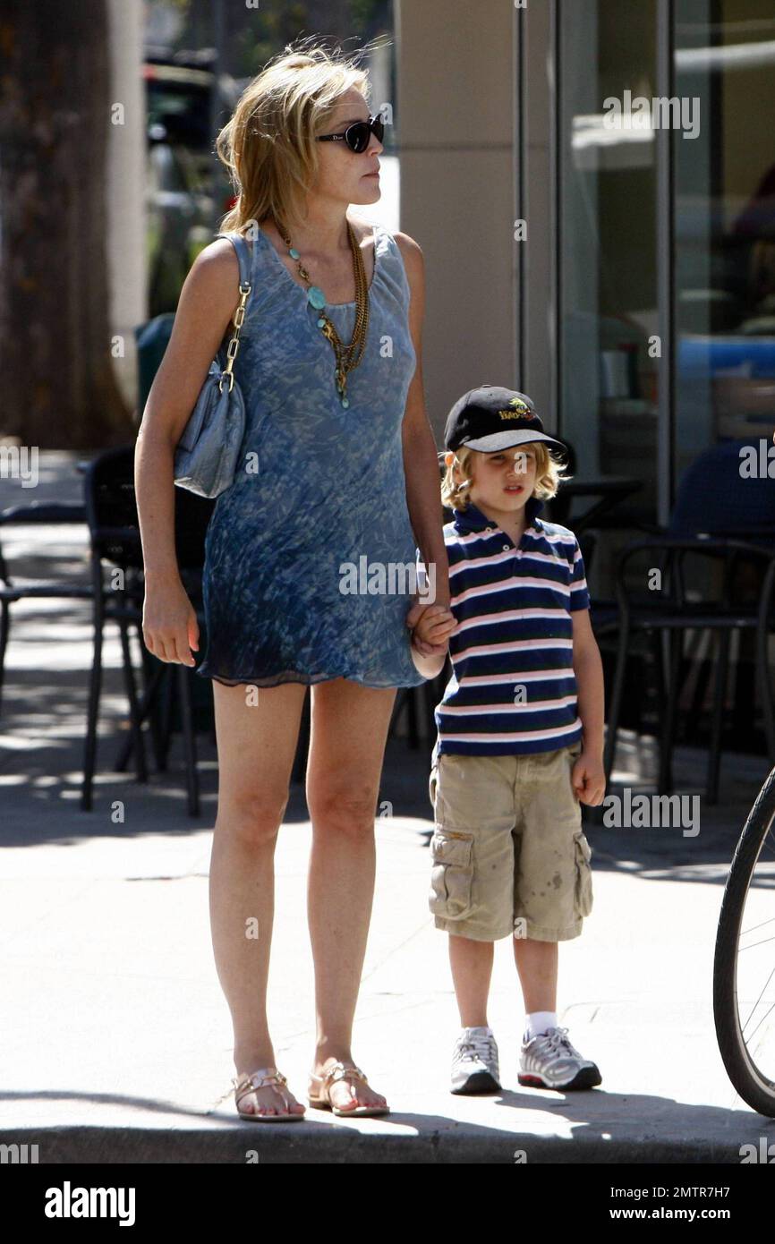 Wearing a simple blue dress and sandals, Sharon Stone takes son Laird ...