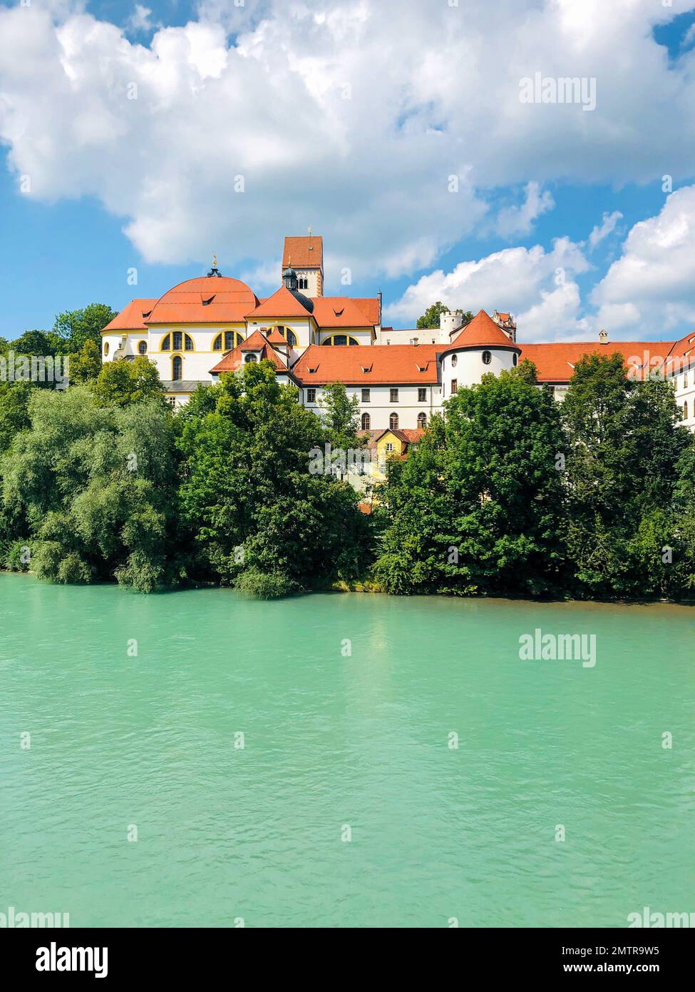 The blue waters of the river with the green trees with beautiful ...