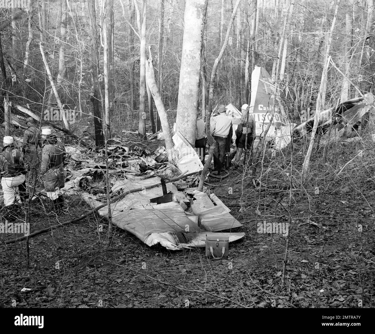 Rescue workers search through the wreckage of a Capital Airlines plane ...