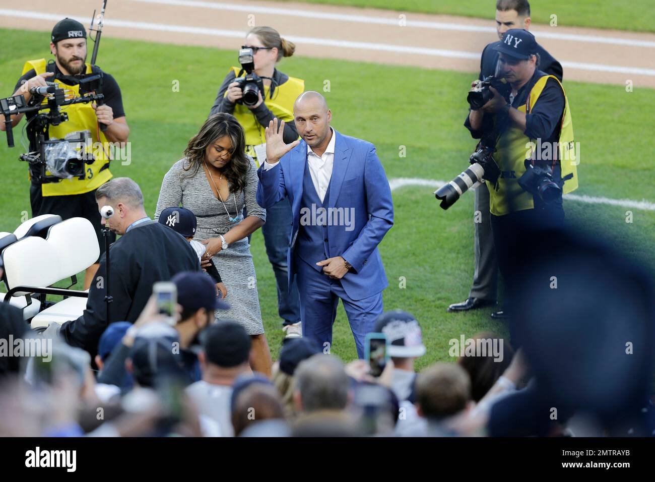 Former New York Yankee Derek Jeter waves to fans during a ceremony ...