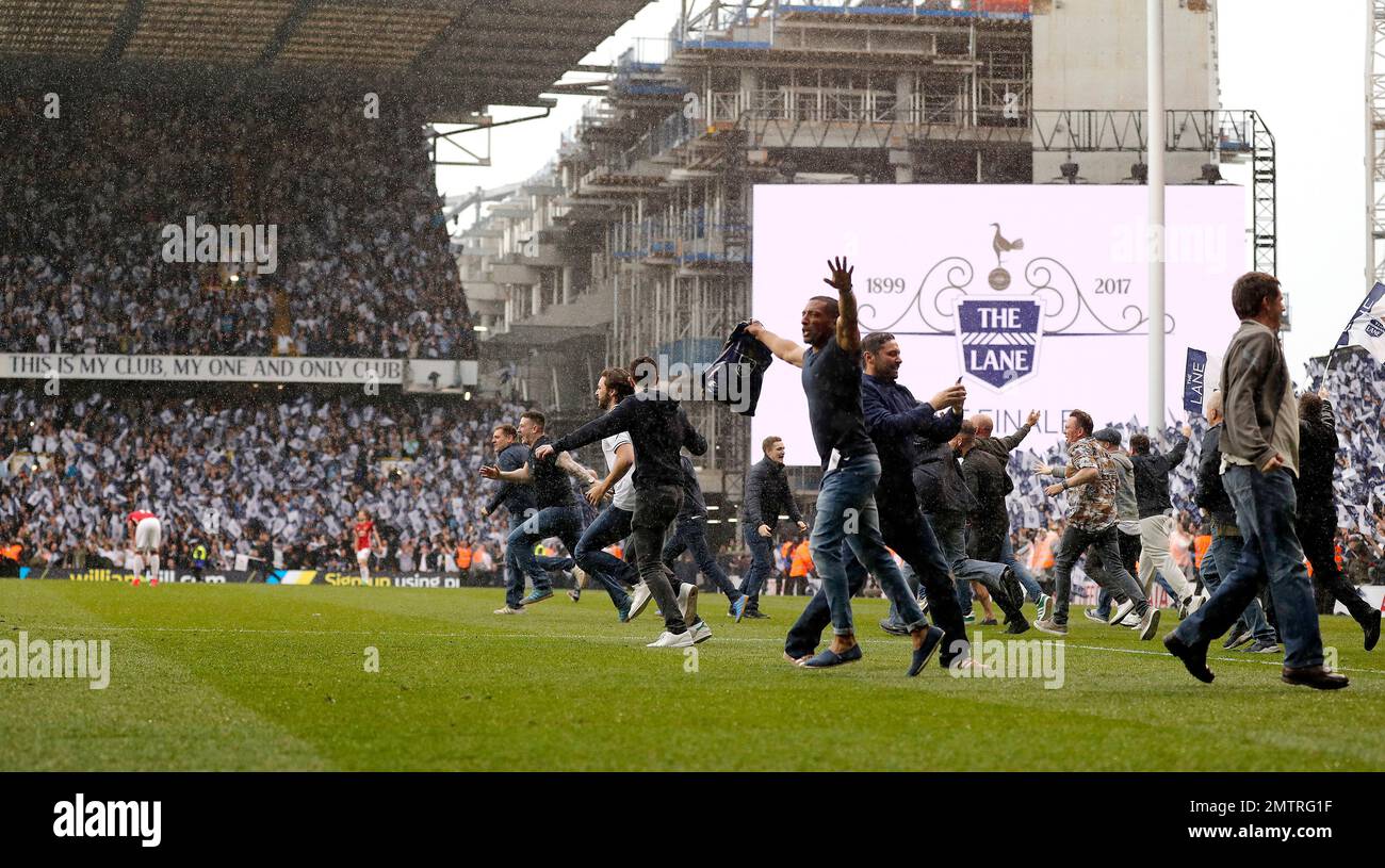 Fans invade the pitch after the English Premier League soccer match ...