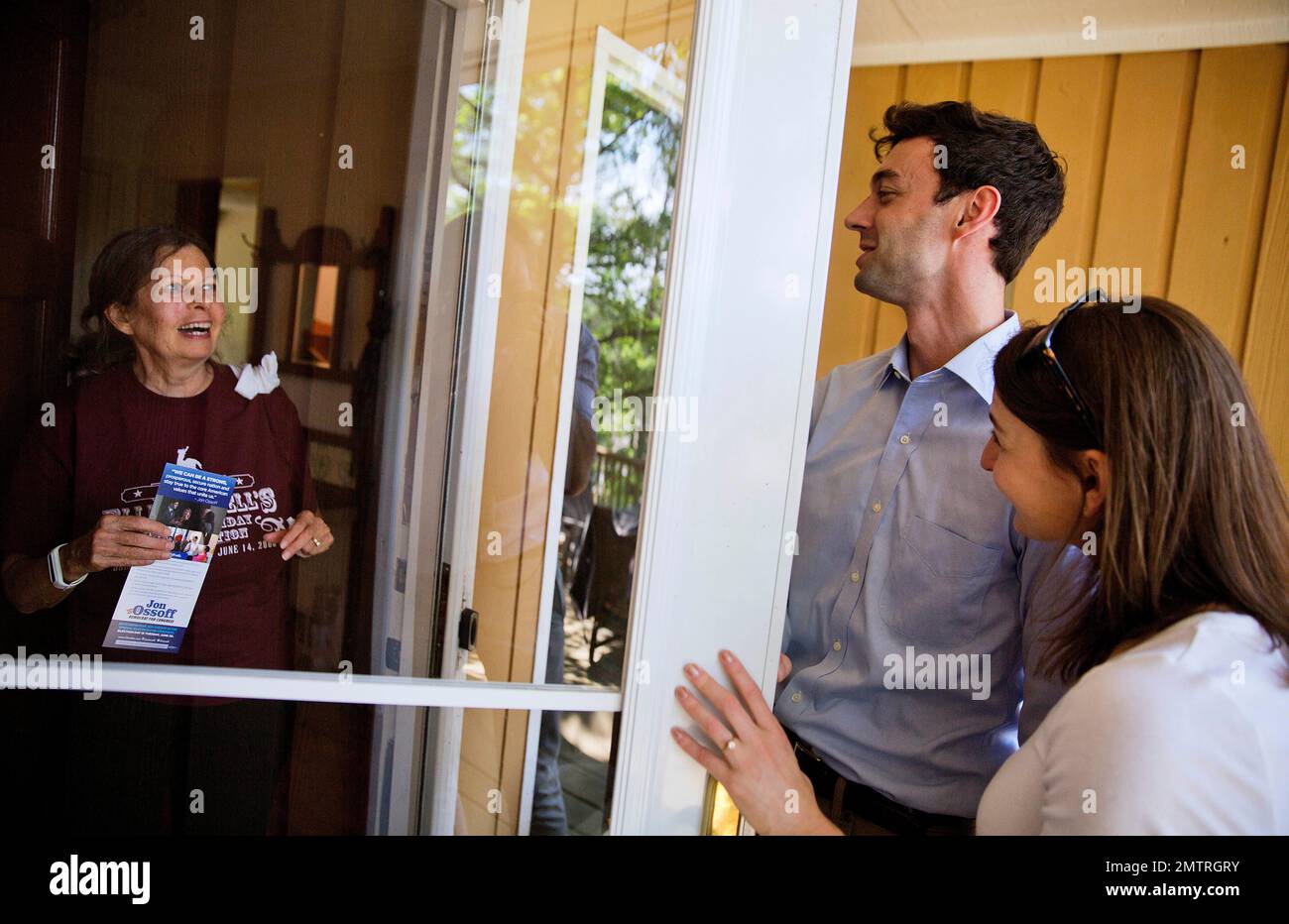 Marilyn Matlock, left, answers her door to Jon Ossoff, center, a 30 ...