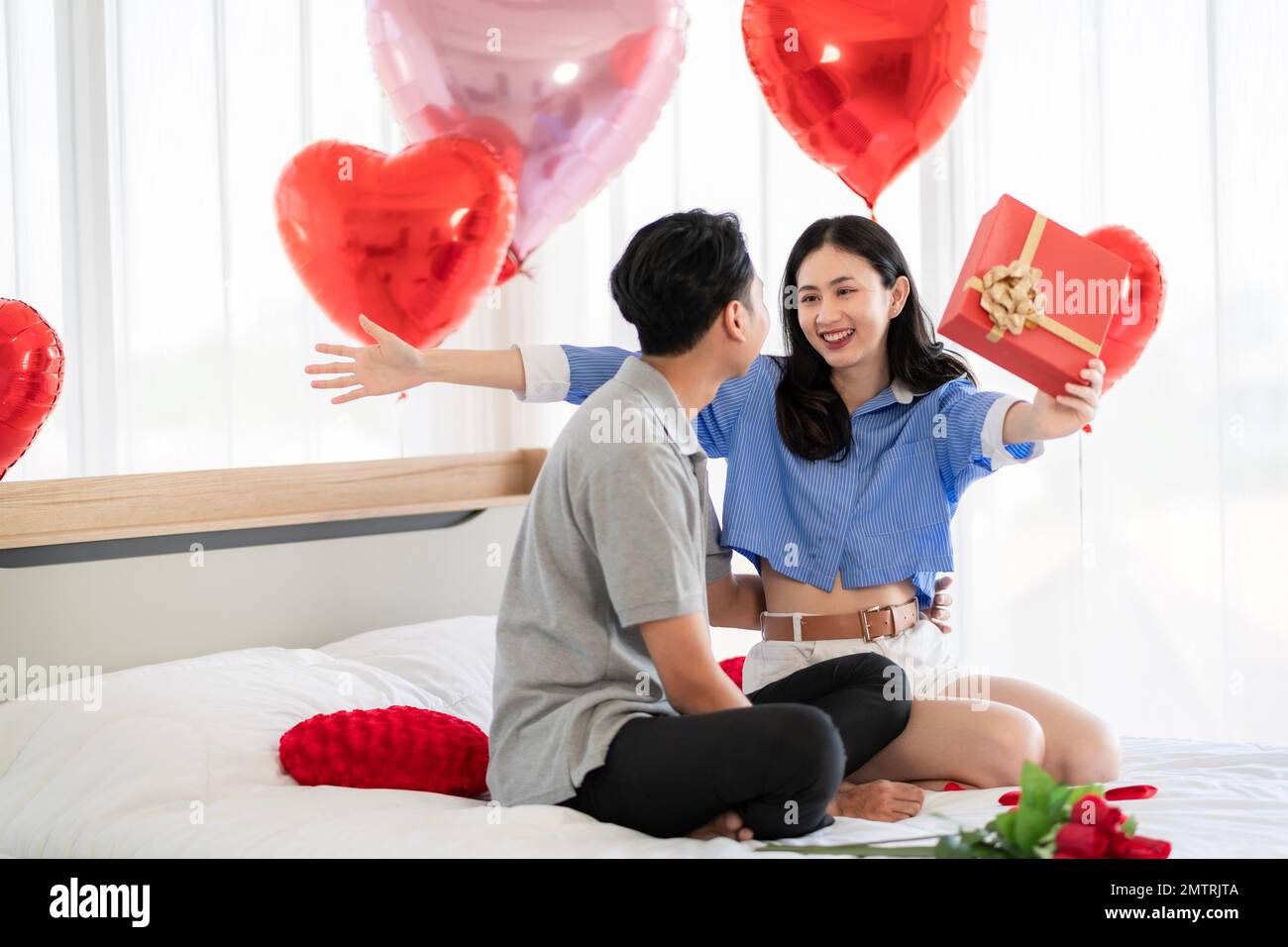 Asian couple Showing love surprise giving flowers or gifts to each ...