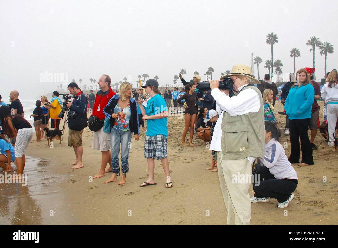 Dogs and their owners participate in the 2nd annual Surf City Surf Dog ...