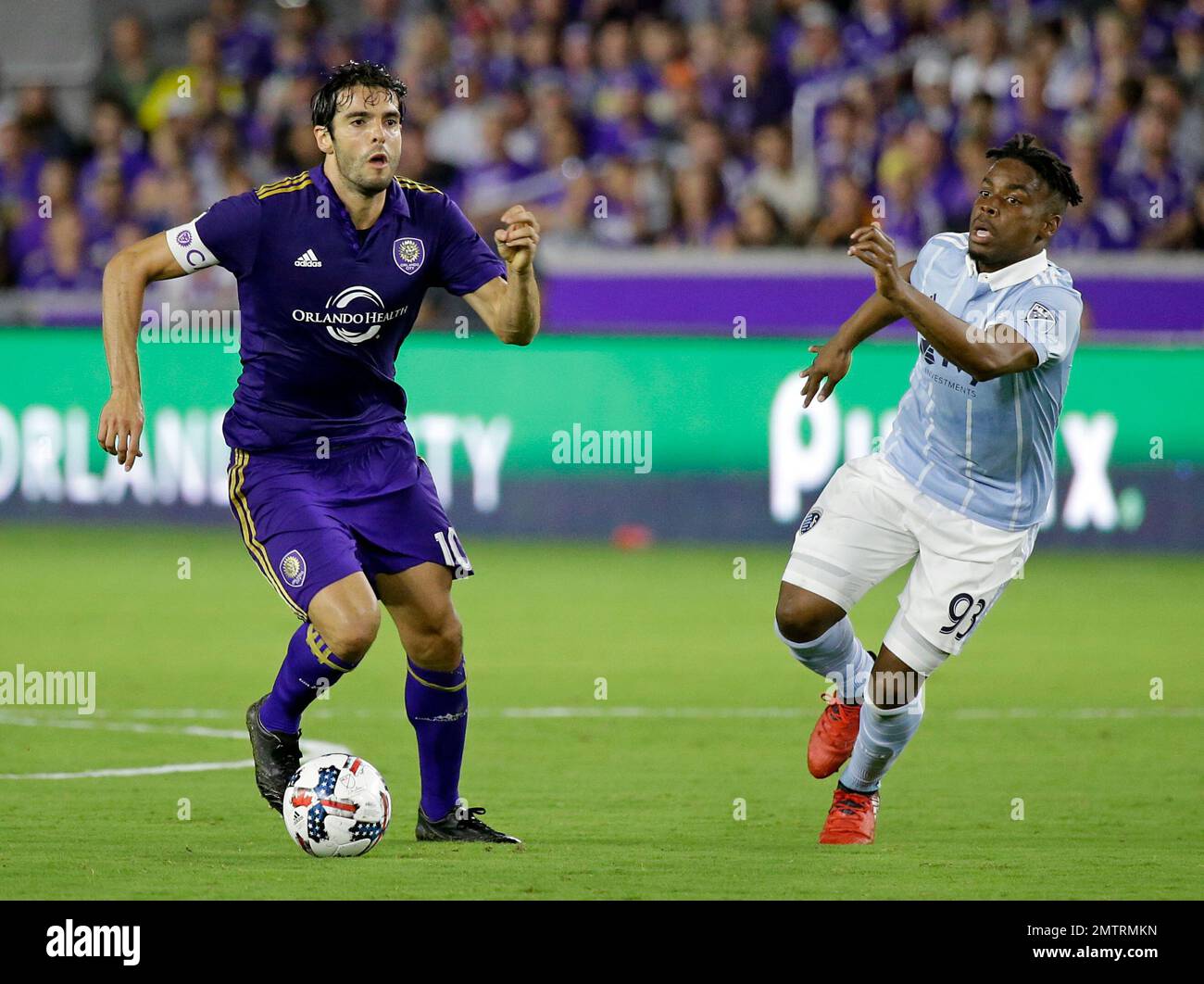 Orlando City's Kaka, left, moves the ball past Sporting Kansas City's ...