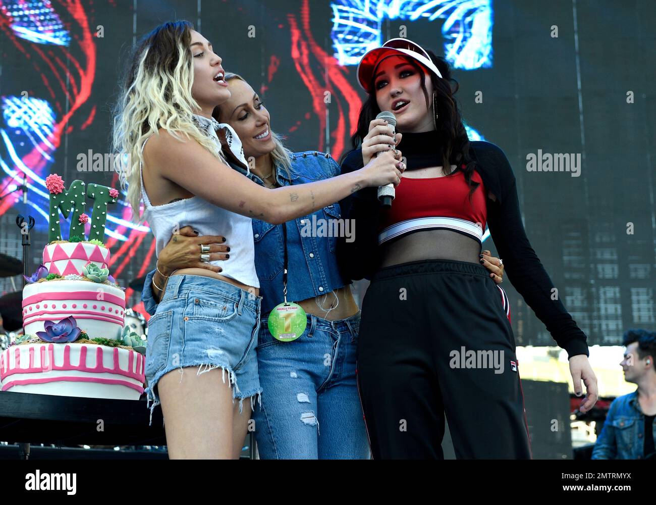 Miley Cyrus, left, and her sister Noah Cyrus, right, sing "Happy ...