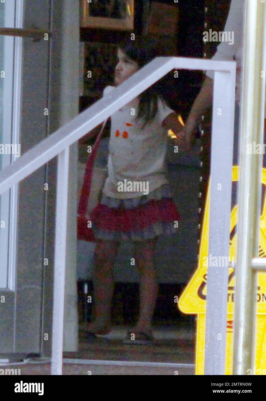 Suri Cruise leaves a luxury hotel accompanied by friends and adult ...