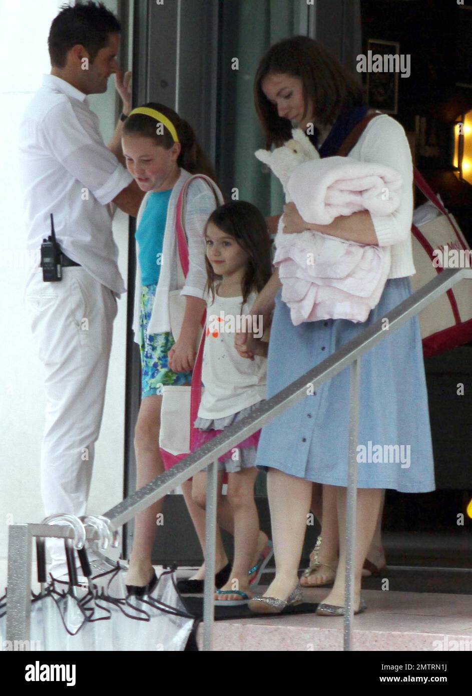 Suri Cruise leaves a luxury hotel accompanied by friends and adult ...