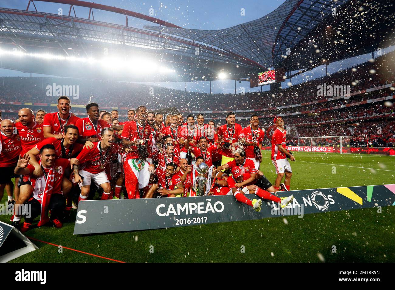 Benfica players celebrate with sparkling wine and the Portuguese league ...