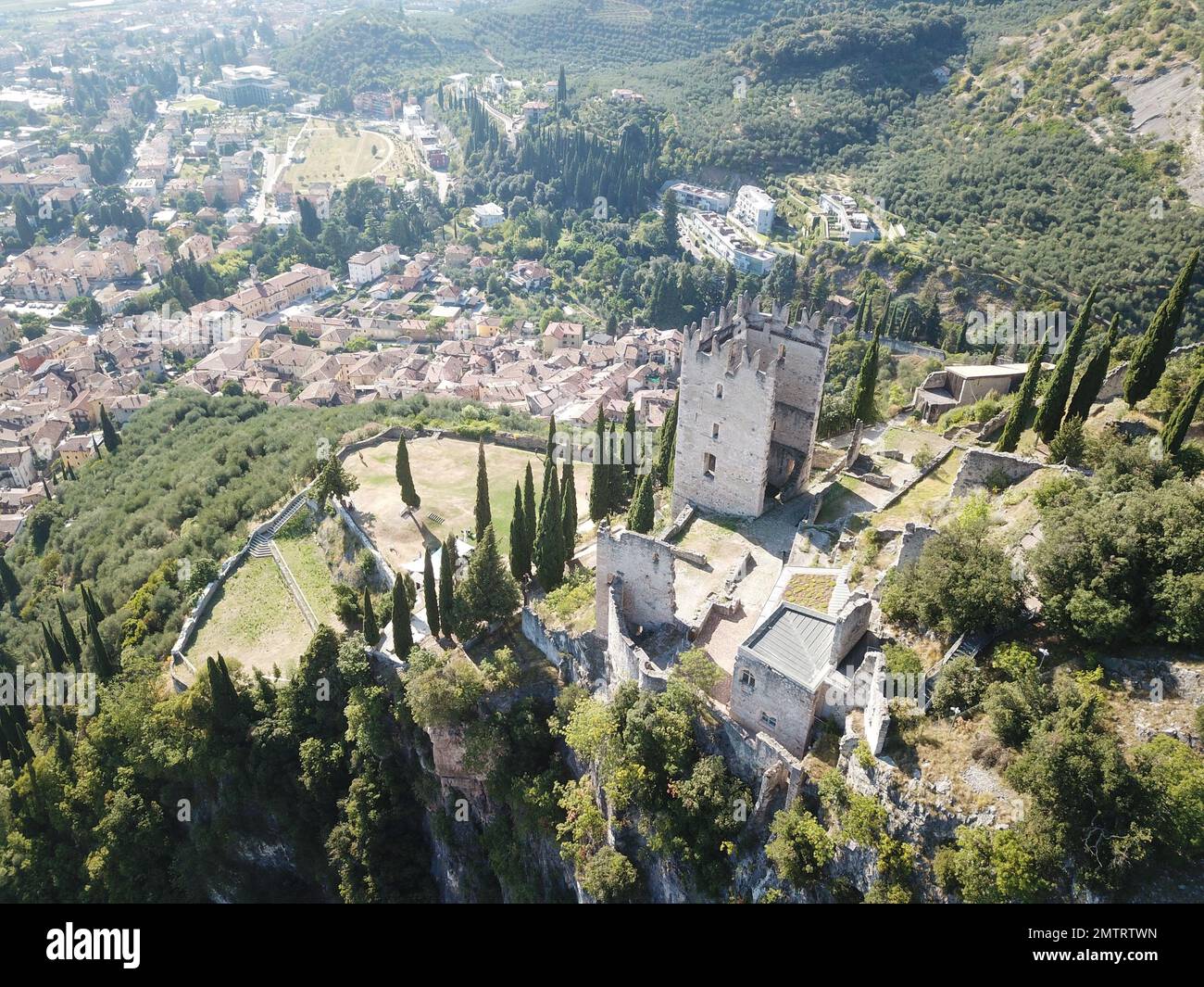 An aerial of the medieval Arco Castle in Italy on top of the mountains ...