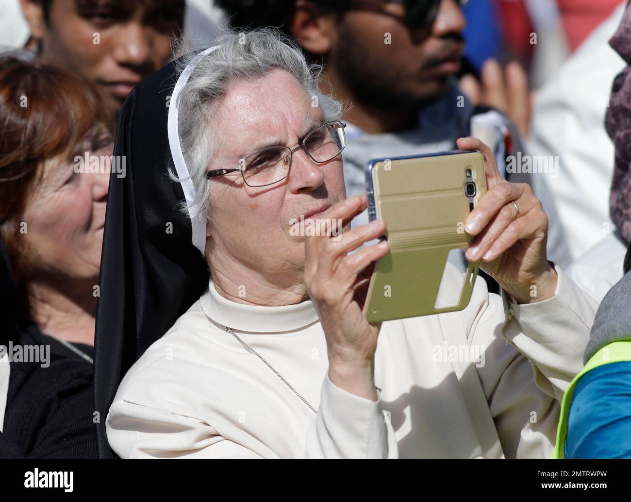 A nun takes images during an open-air solemn Mass by Pope Francis to ...