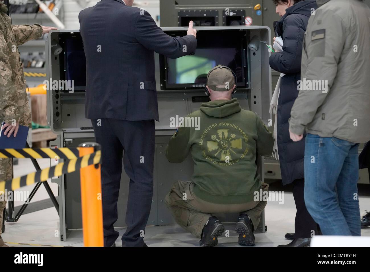 Ukrainian Minister of Defense Oleksii Reznikov, center, looks at the ...