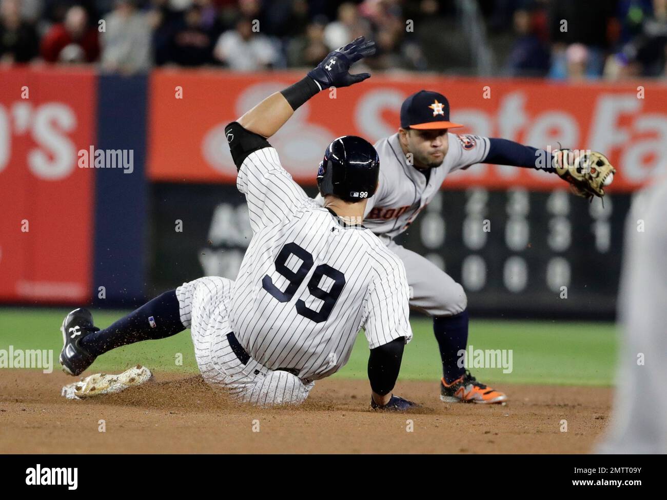 New York Yankees' Aaron Judge (99) slides into second base with a ...