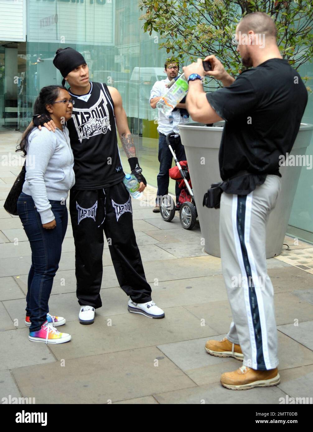 The Black Eyed Peas' Taboo (aka Jaime Luis Gomez) stops to pose for photos with fans as he heads ...