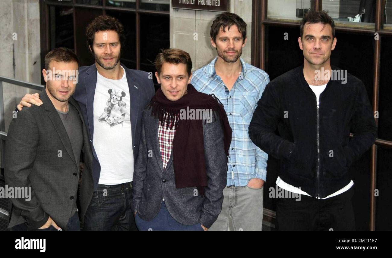 Robbie Williams, 36, shows off some grey hair as he arrives with his ...