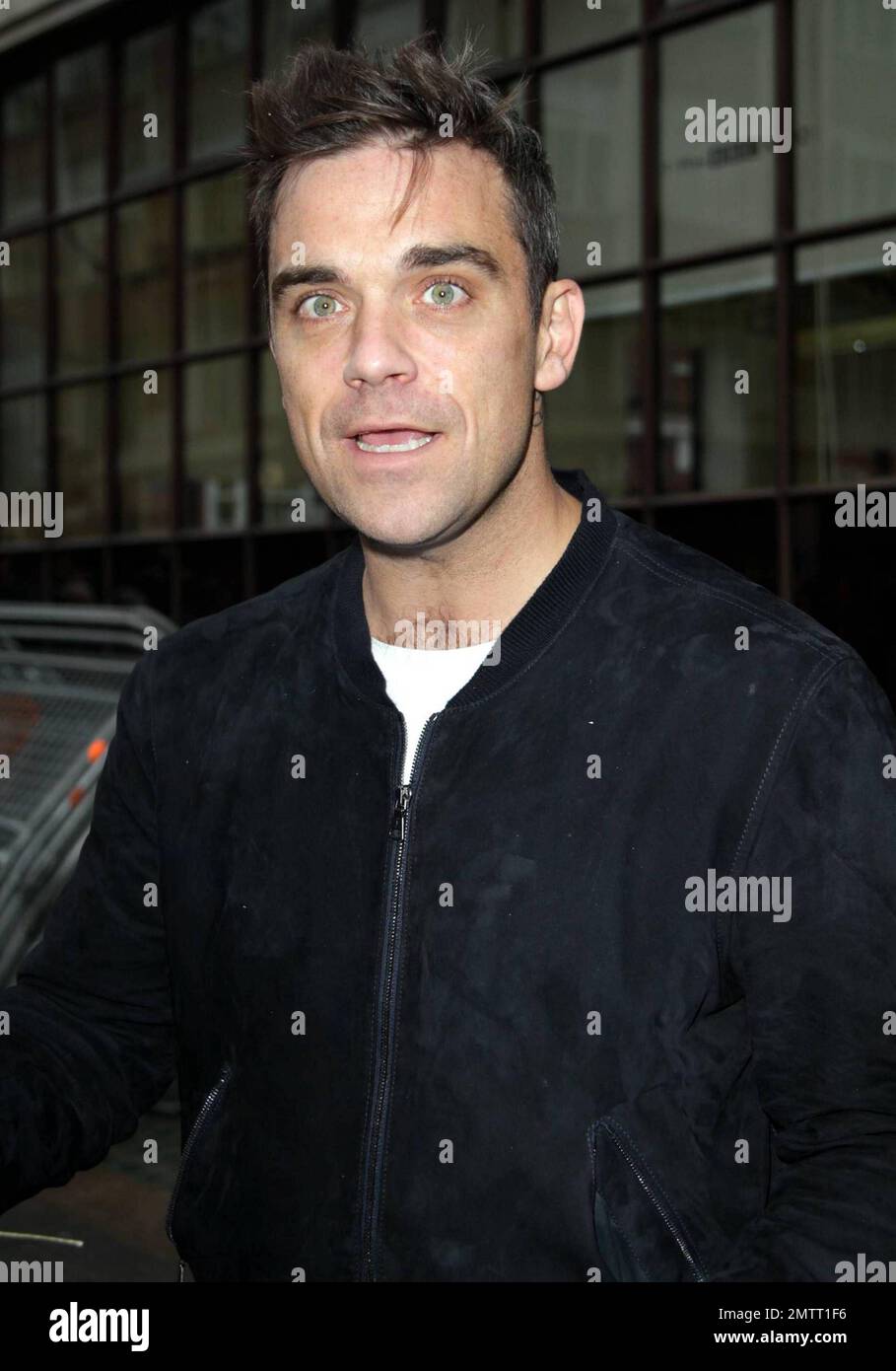 Robbie Williams, 36, shows off some grey hair as he arrives with his ...